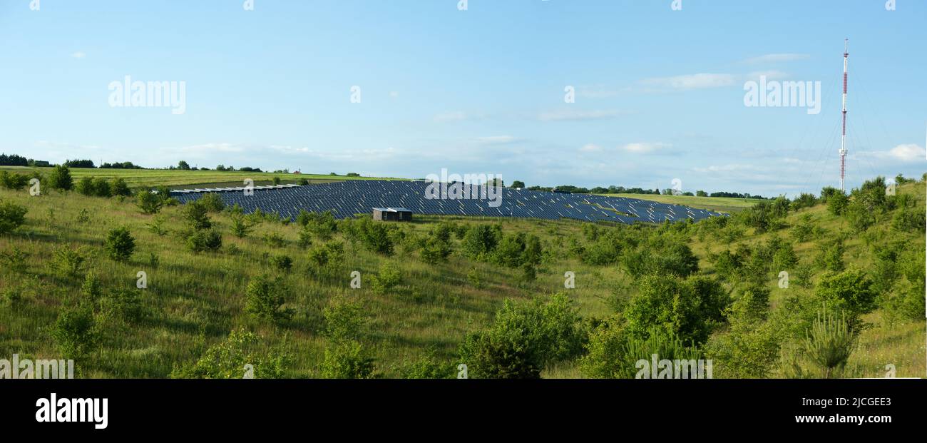 big panoramic view of large solar panel station on the hills on a ...