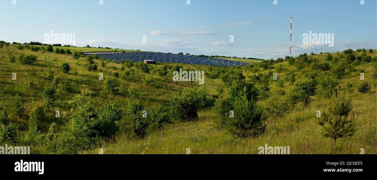 big panoramic view of large solar panel station on the hills on a ...