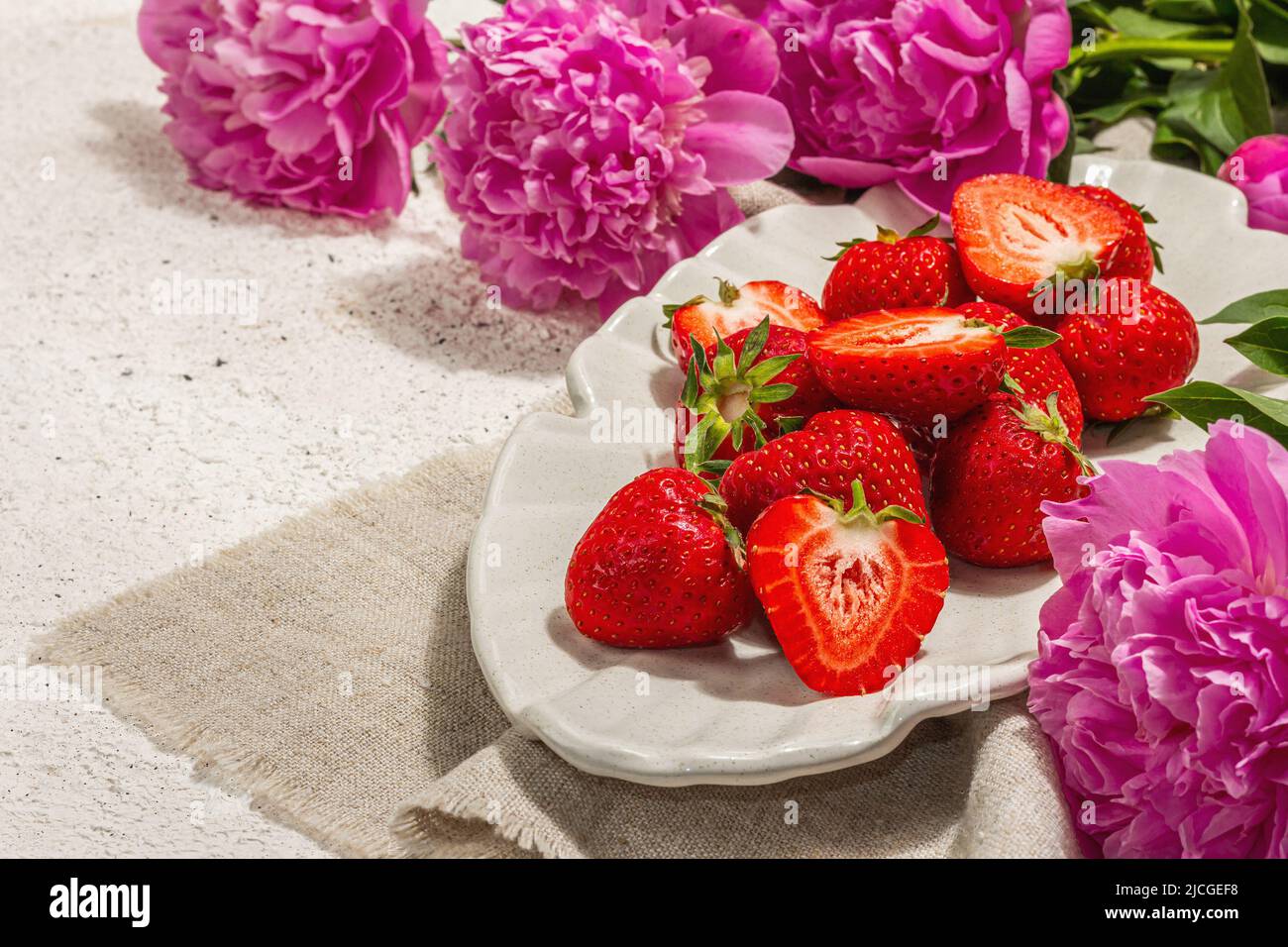 Sweet ripe strawberries and fragrant peonies bouquet. Summer plaster ...