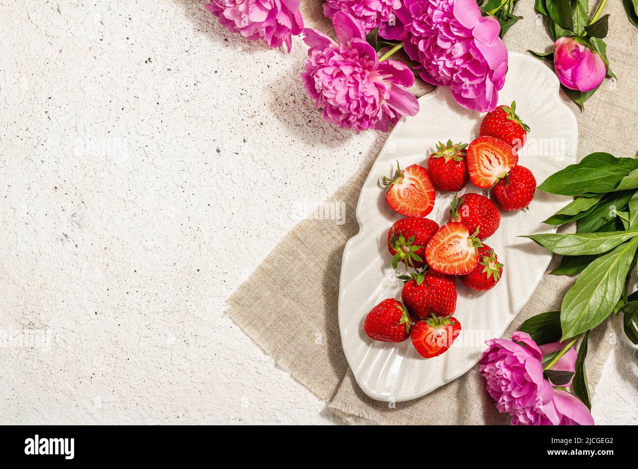 Sweet ripe strawberries and fragrant peonies bouquet. Summer plaster ...