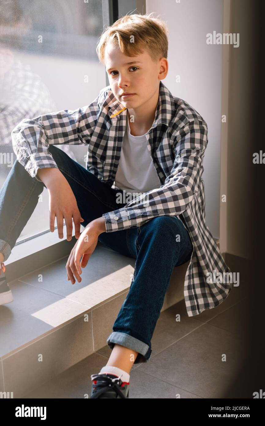 High perspective portrait of an attractive teenage boy sitting on the ...
