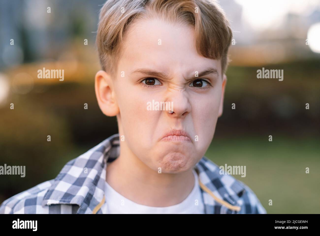 Naughty teenager blond makes faces, indulges and fools around. Carefree ...