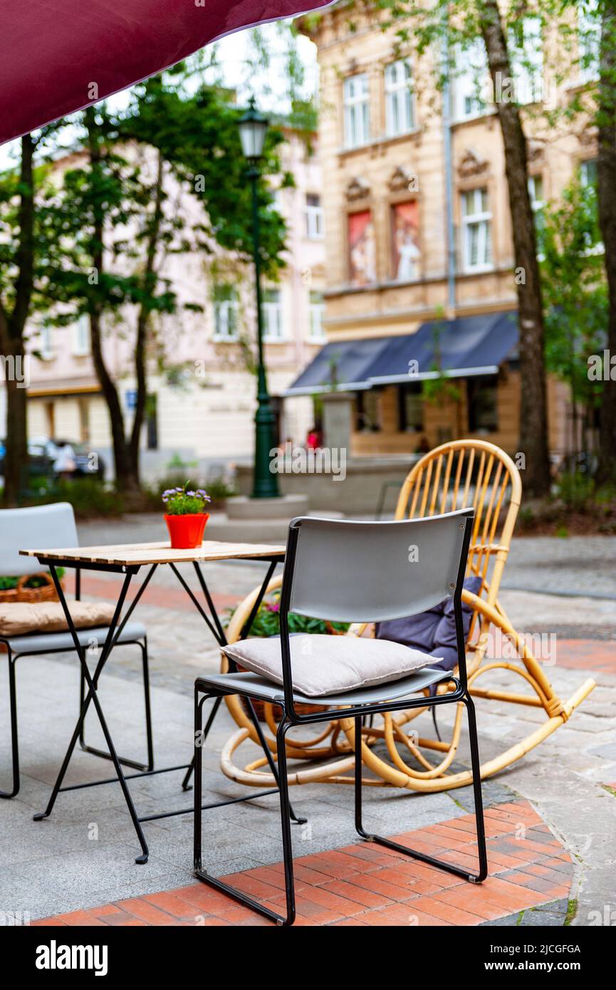 Outdoor cafe in the old town. Chairs and table on empty terrace at cafe ...