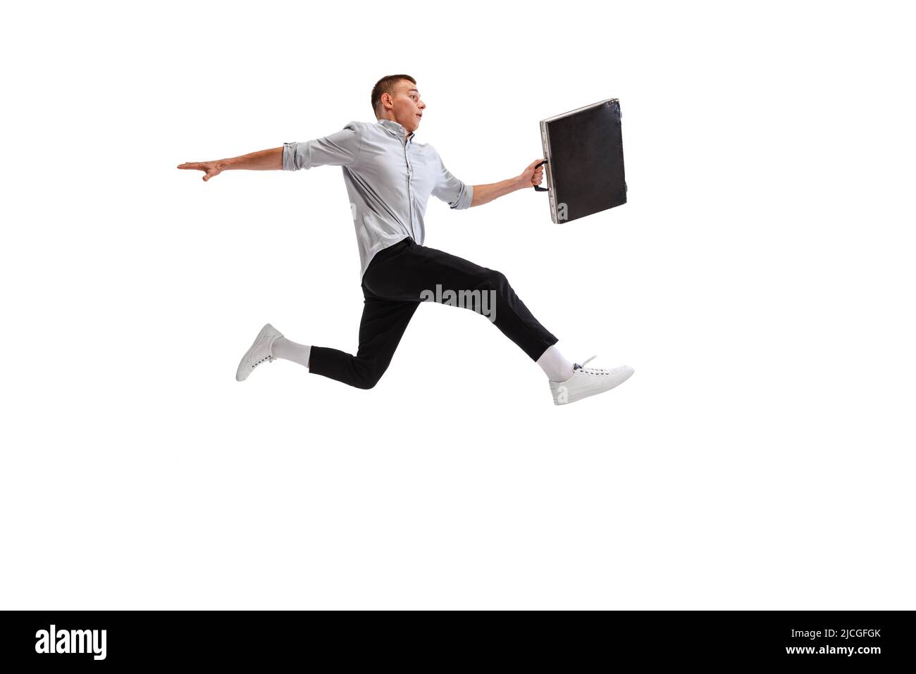 Portrait of young man. office worker jumping over obstacle with ...