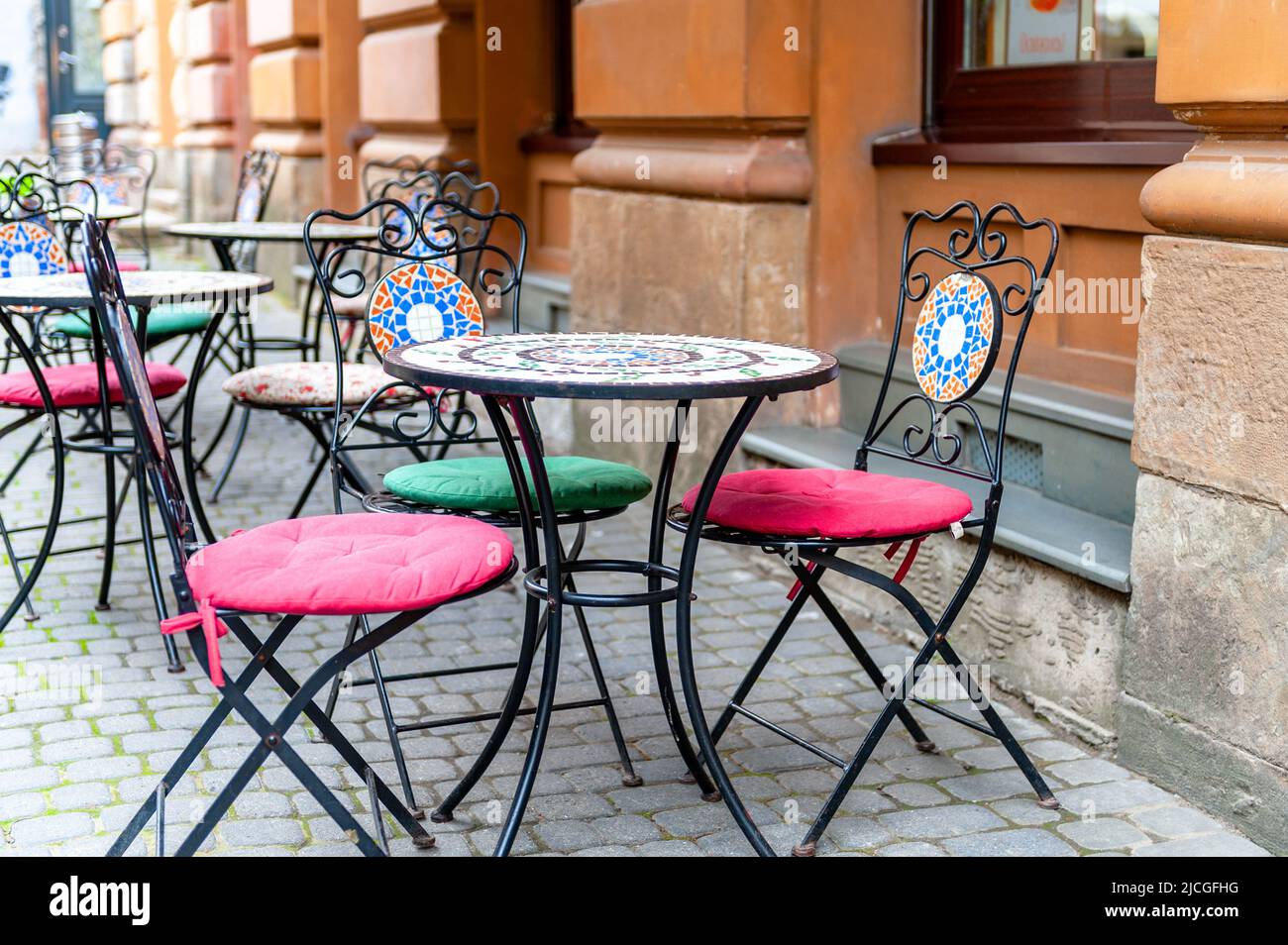 Outdoor cafe in the old town. Chairs and table on empty terrace at cafe ...