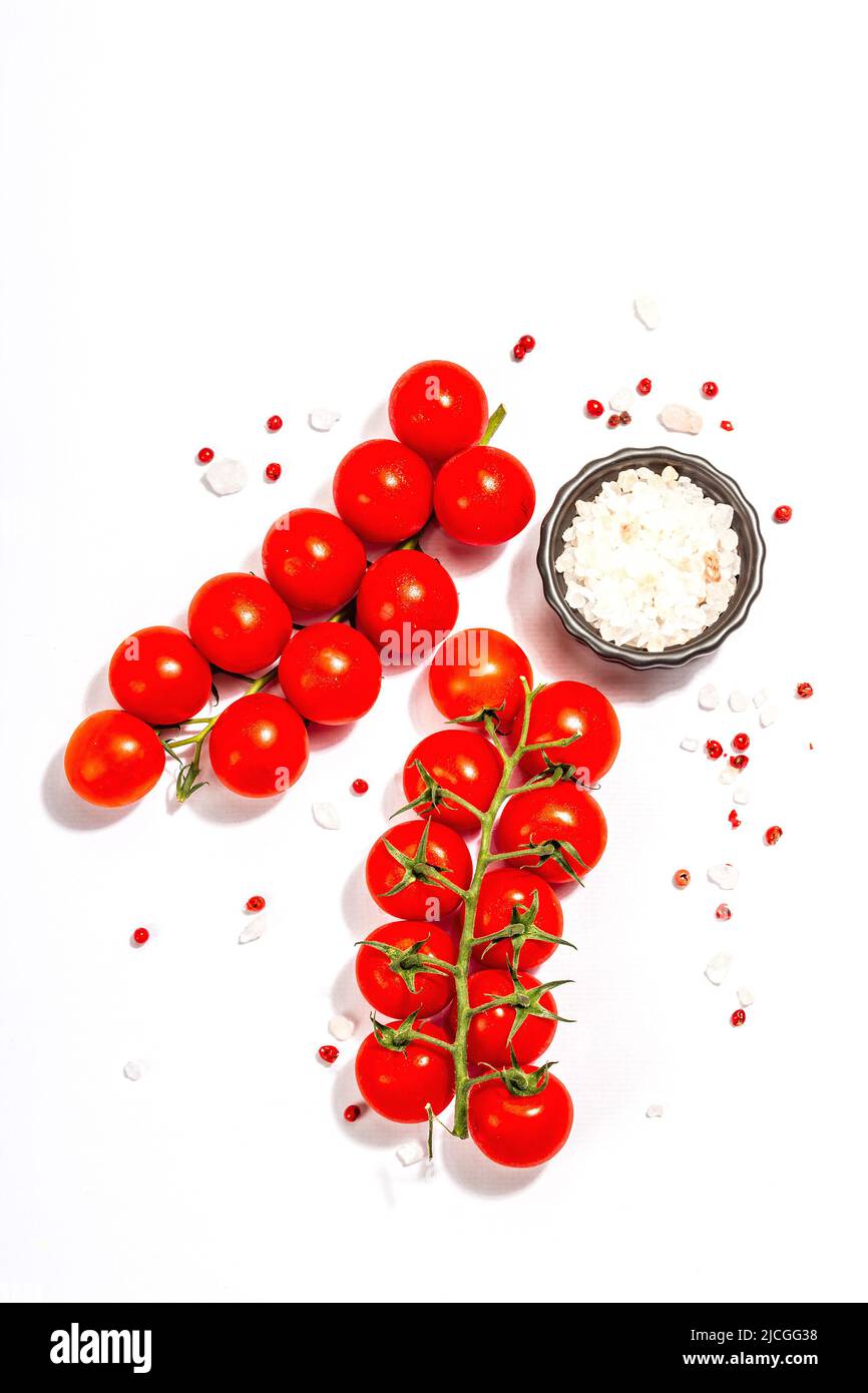 Cooking background with tomato cherry, sea salt, and rose peppercorn ...