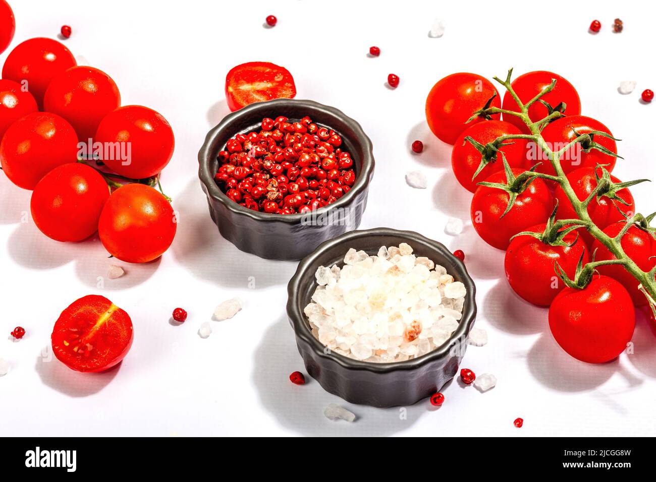 Cooking background with tomato cherry, sea salt, and rose peppercorn ...