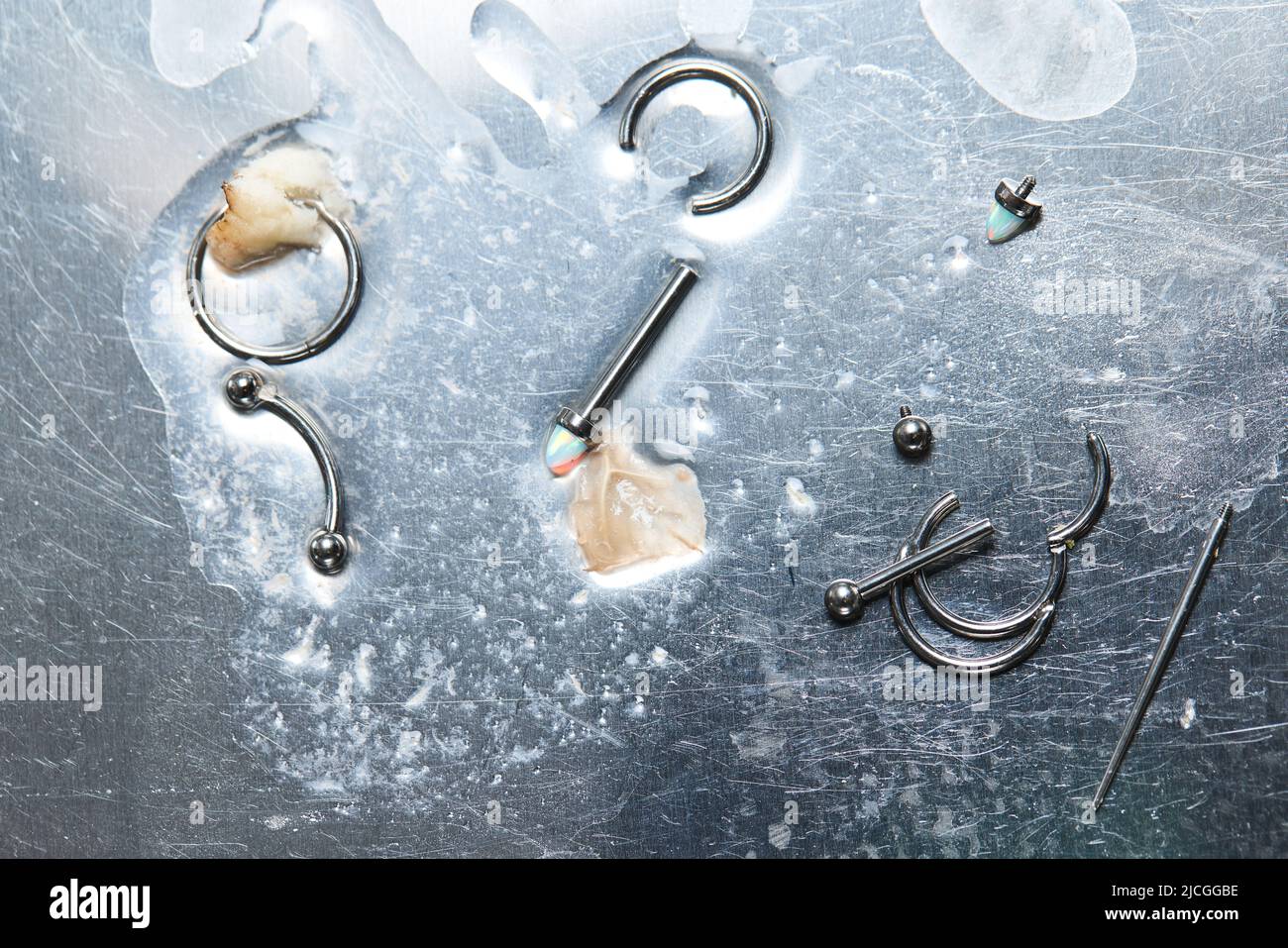 Piercing earrings close-up. On a black background Stock Photo - Alamy