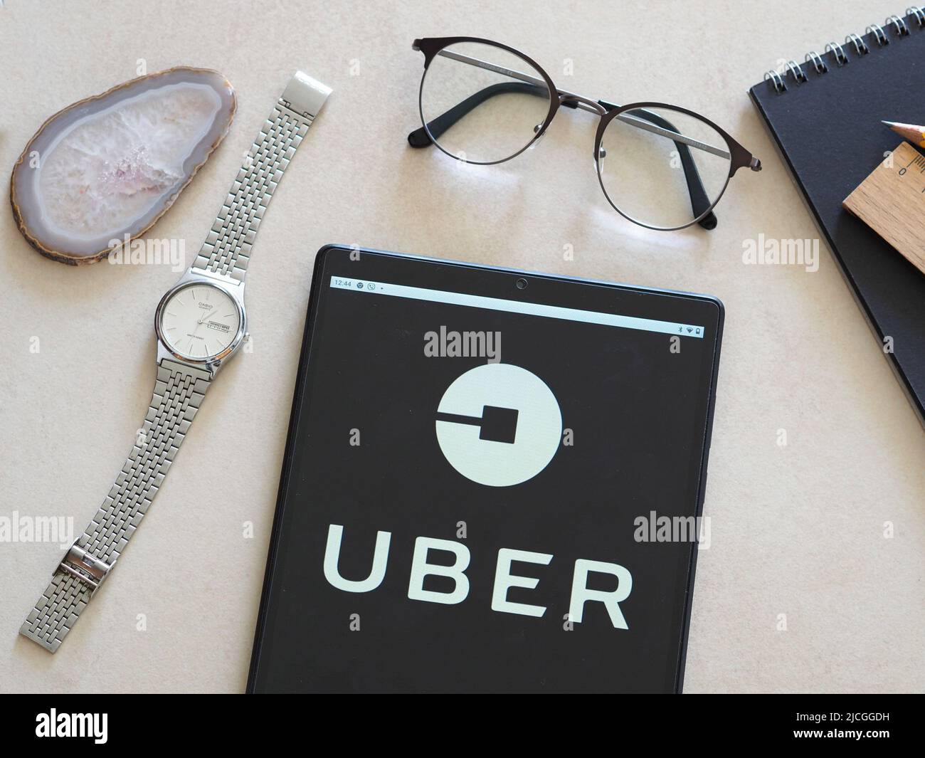In this photo illustration, the Uber Technologies Inc. logo seen displayed on a tablet Stock ...