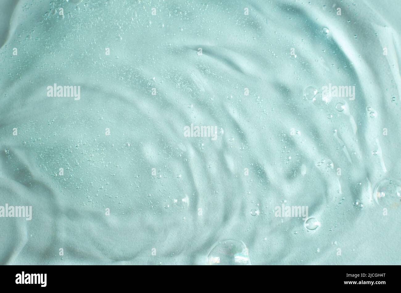 Green transparent gel texture filled with air bubbles. Development of ...