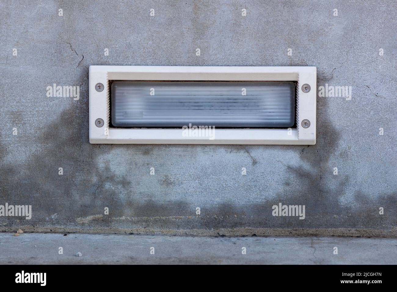 Fixed stair light embedded in concert with a white frame. Photographer ...