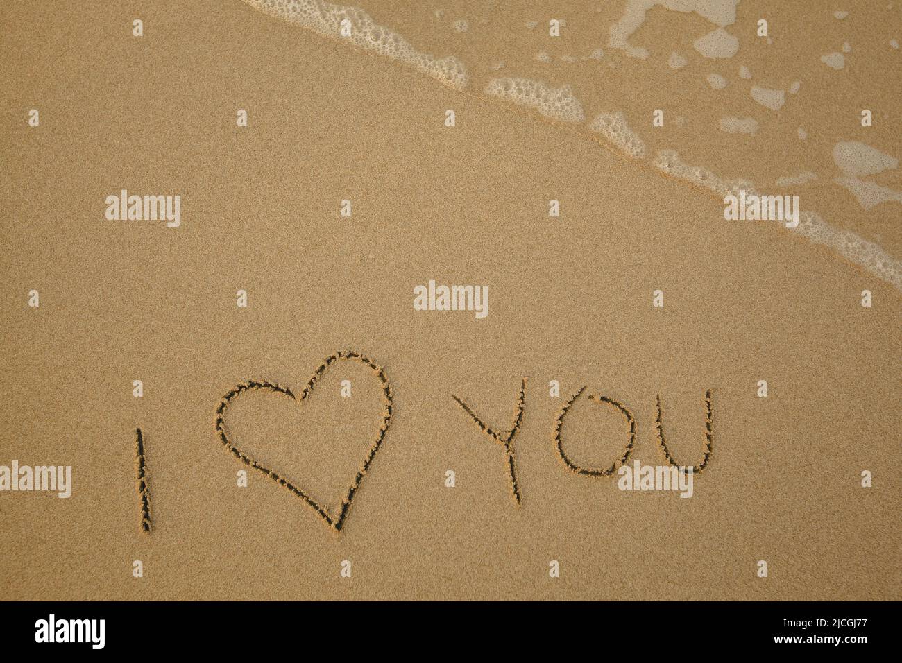 I love You - handwritten on the soft beach sand Stock Photo - Alamy