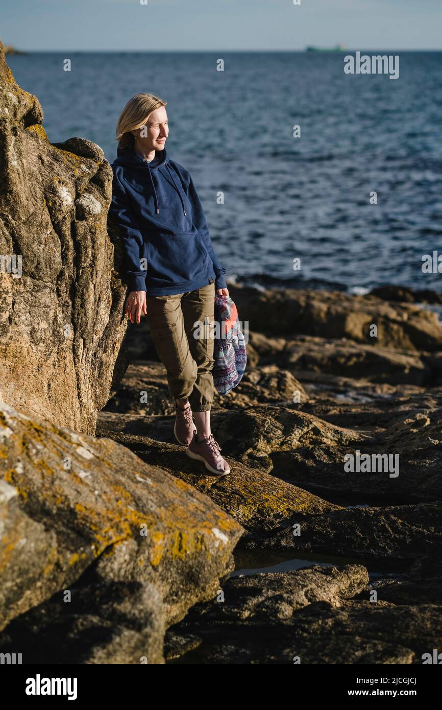 Woman sea stone stands hi-res stock photography and images - Alamy