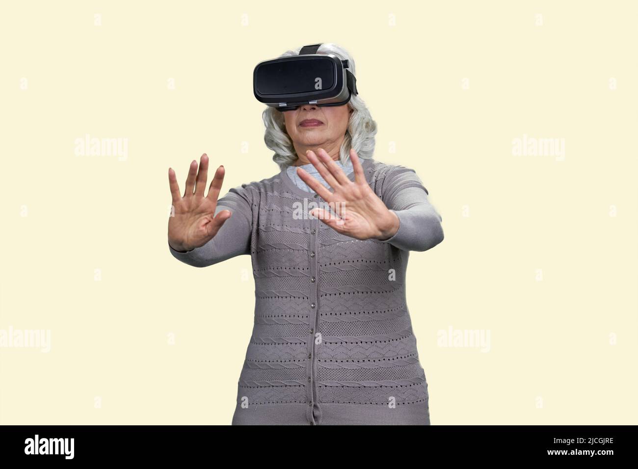Old lady shocked experiencing virtual reality headset. Isolated on ...
