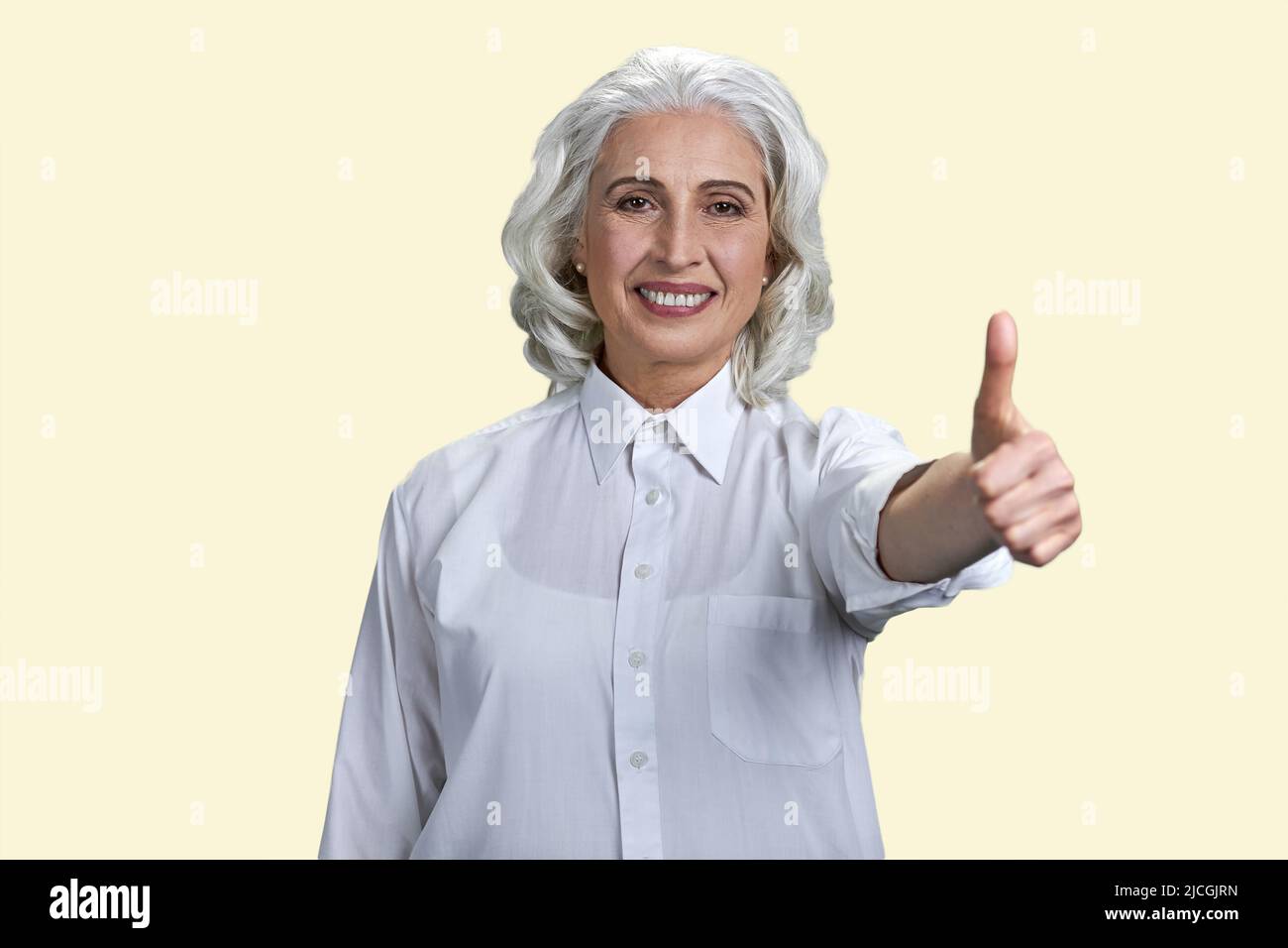 Beautiful smiling senior lady showing thumb up gesture. Isolated on ...