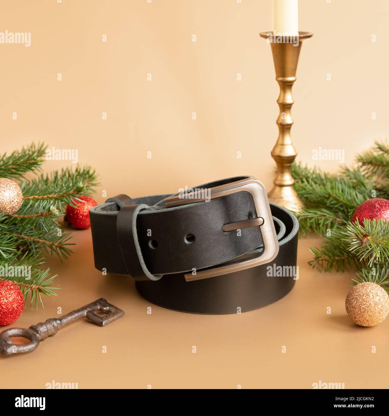 Rolled-up black fashionable men's leather belt with metal buckle ...