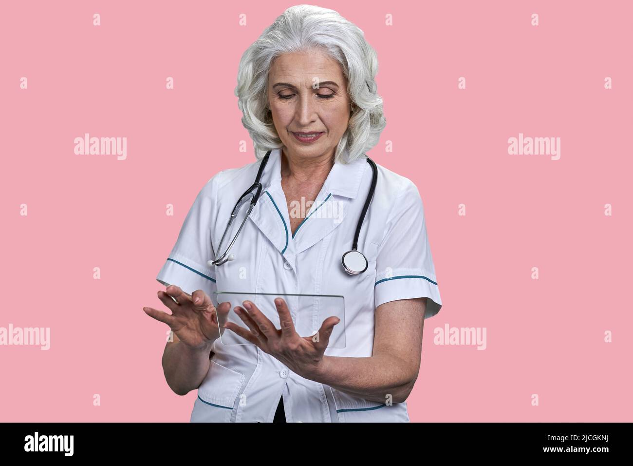 Female doctor with stethoscope using futuristic transparent tablet pc ...