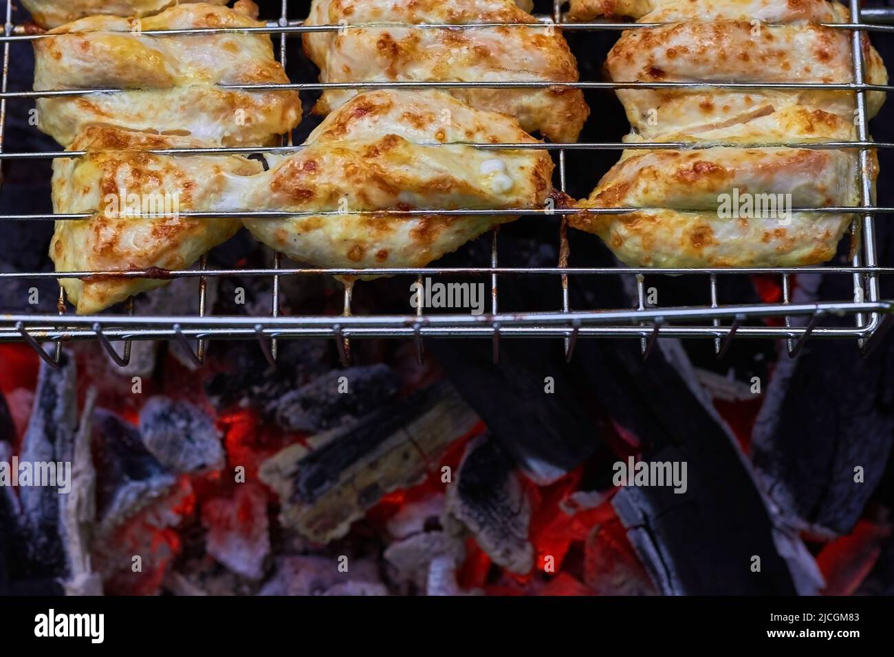 Juicy appetizing grilled chicken slices. Portable grill. Picnic in the ...