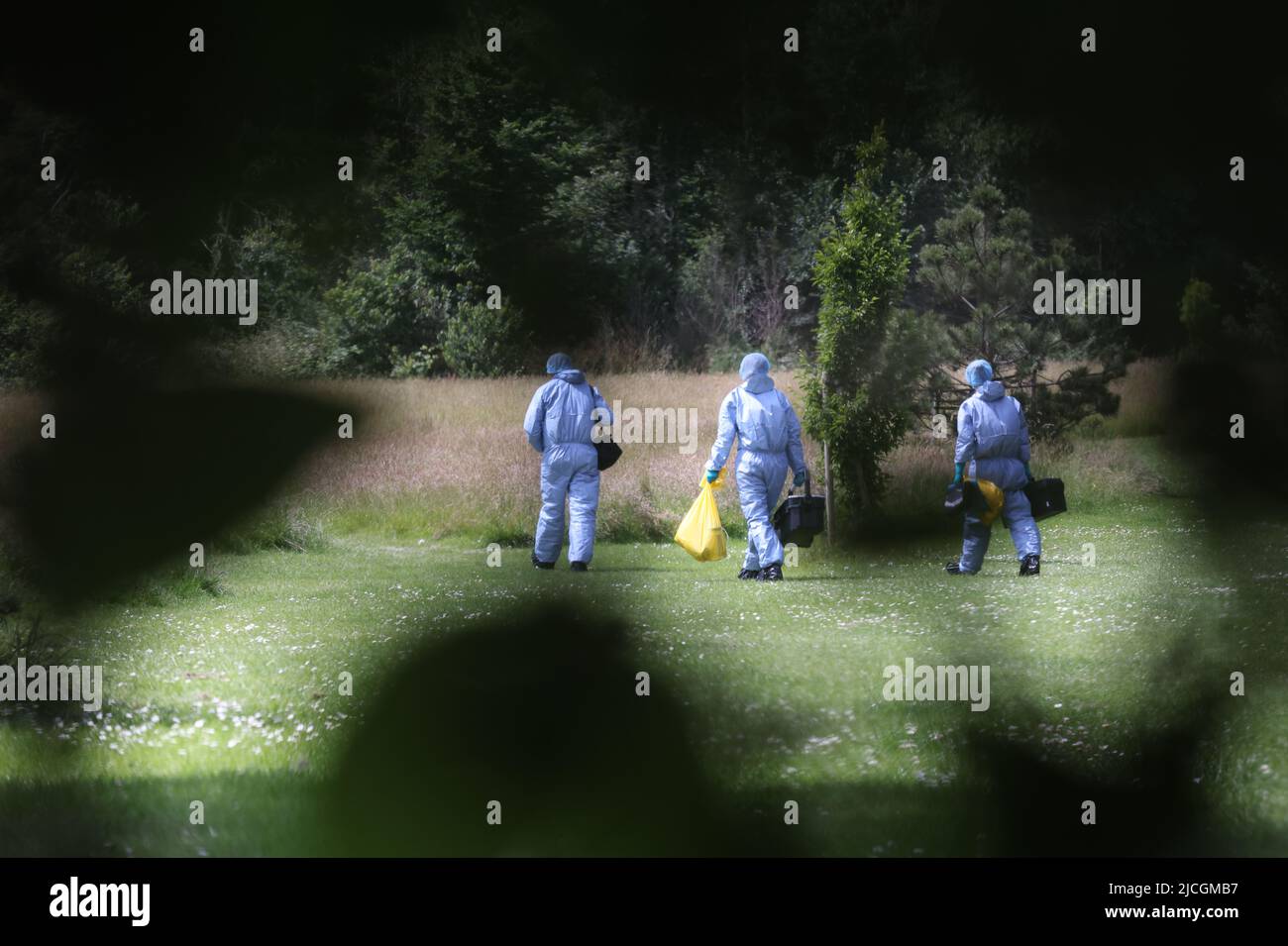 Police forensic officers at the scene where a body was found after a ...