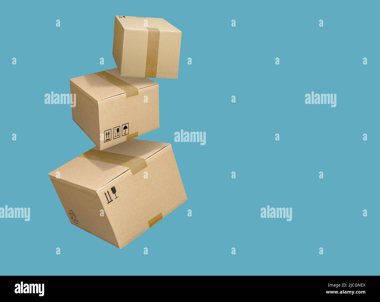 Cardboard parcel boxes falling on turquoise blue background Stock Photo ...
