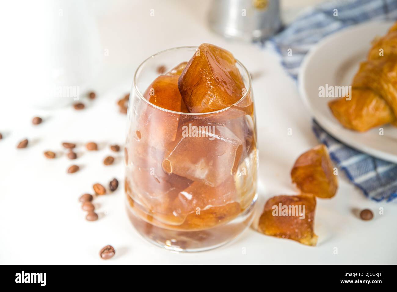 Cold coffee cocktail with frozen coffee espresso ice cubes and milk ...