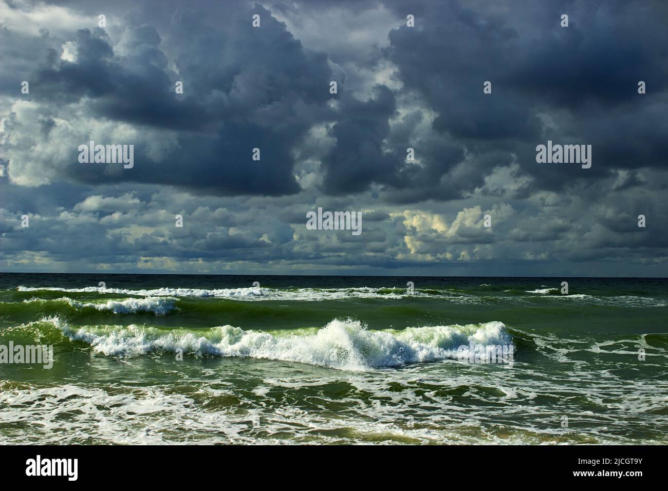 Dramatic sky with dark clouds and stormy sea with rolling waves Stock ...