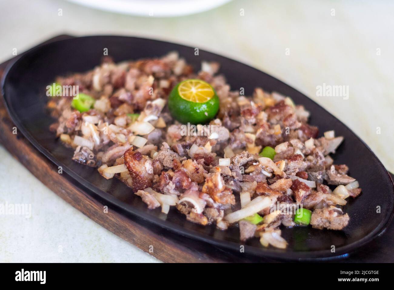 A sizzling sisig dish at Cafe Mamia in Dumaguete City, Philippines ...
