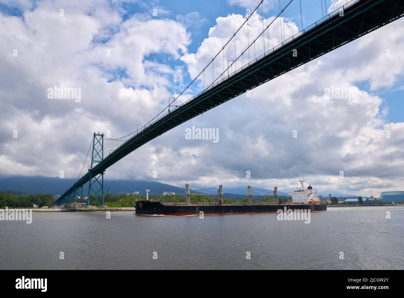Freighter Departing Vancouver Lion's Gate Bridge. A freighter departs ...