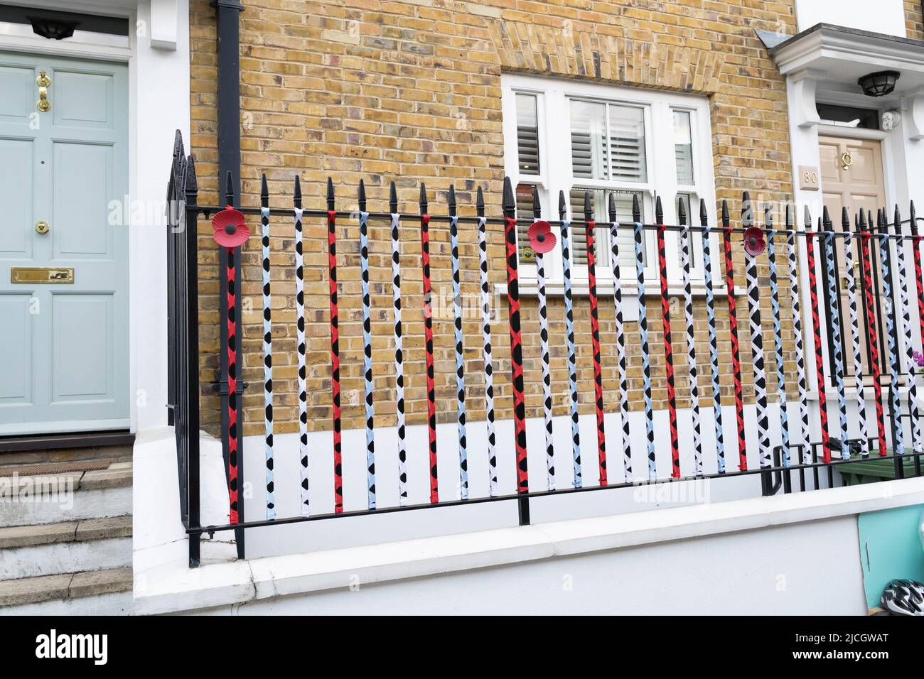 Poppy appeal ribbons wrapped around the metal fence railings at Terrace ...