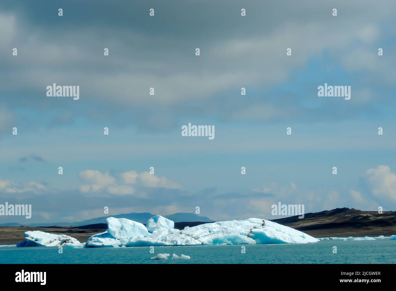 Bright clear blue turquoise iceberg floating in the Jokulsarlon lake ...
