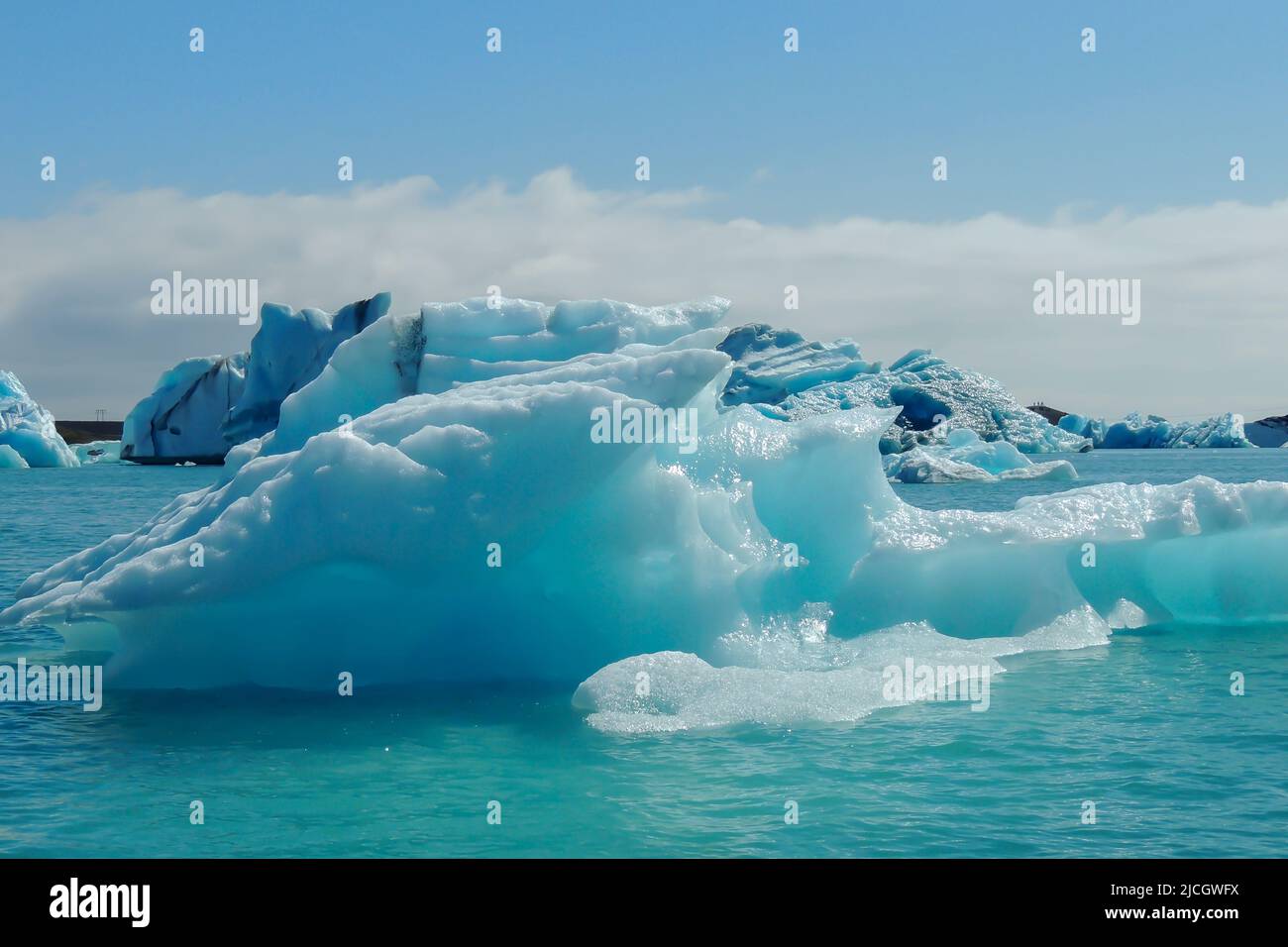 Bright clear blue turquoise iceberg floating in the Jokulsarlon lake ...