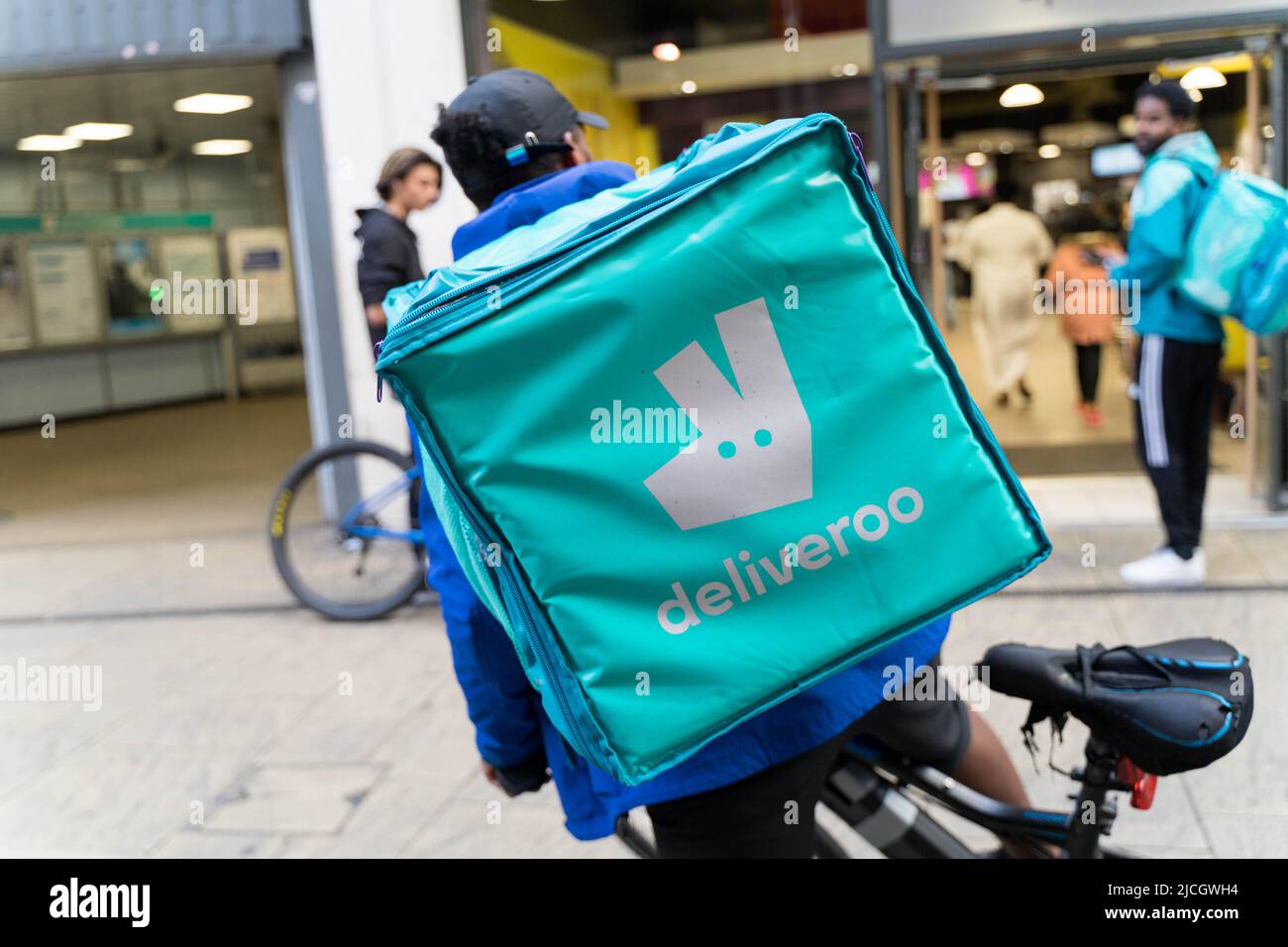 Deliveroo courier greets his fellow Deliveroo before heading off on his ...