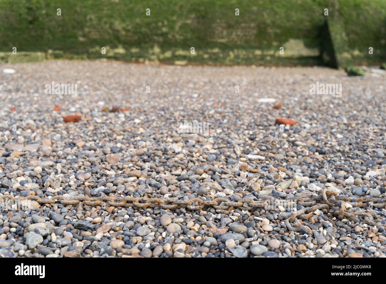 metal chain wriggle along Pebble beach at low tide in River Thames ...