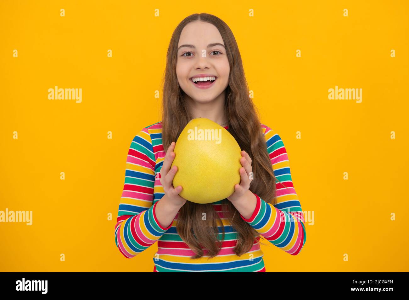 Summer fruits. Teenager child girl hold citrus fruit pummelo or pomelo ...