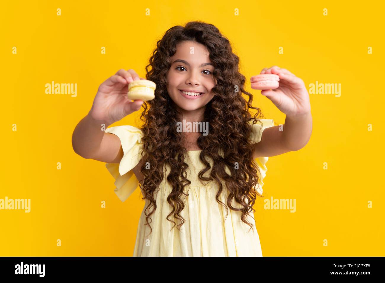 Child girl with dessert bakery. Teenager kid hold french macaron ...