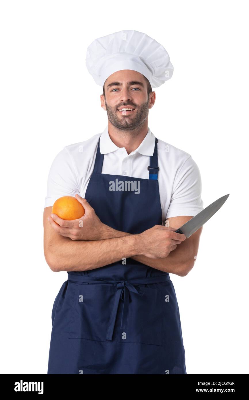 Portrait of a handsome male chef cook holding knife and orange isolated ...
