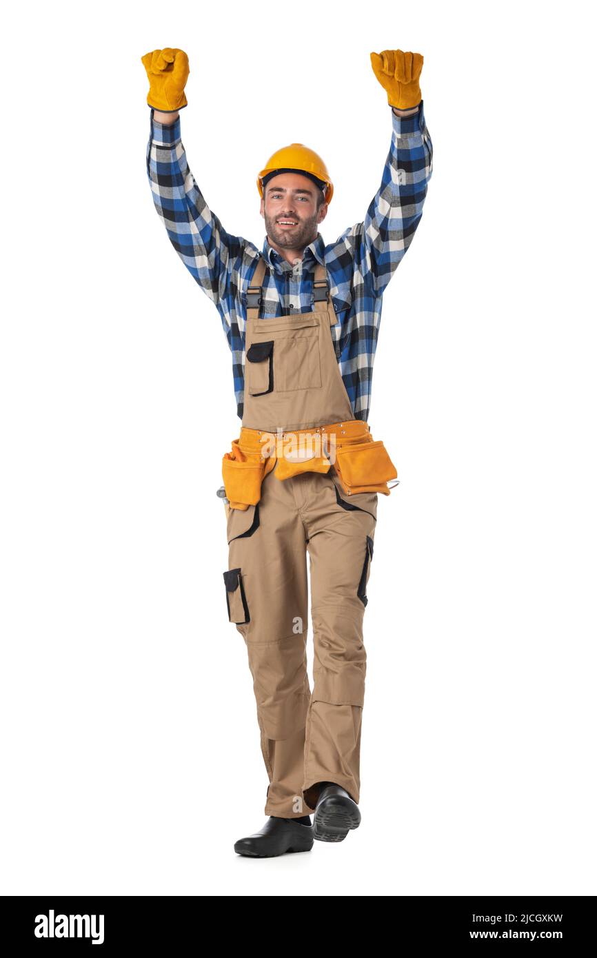 Full length of happy young manual worker with hands raised isolated ...