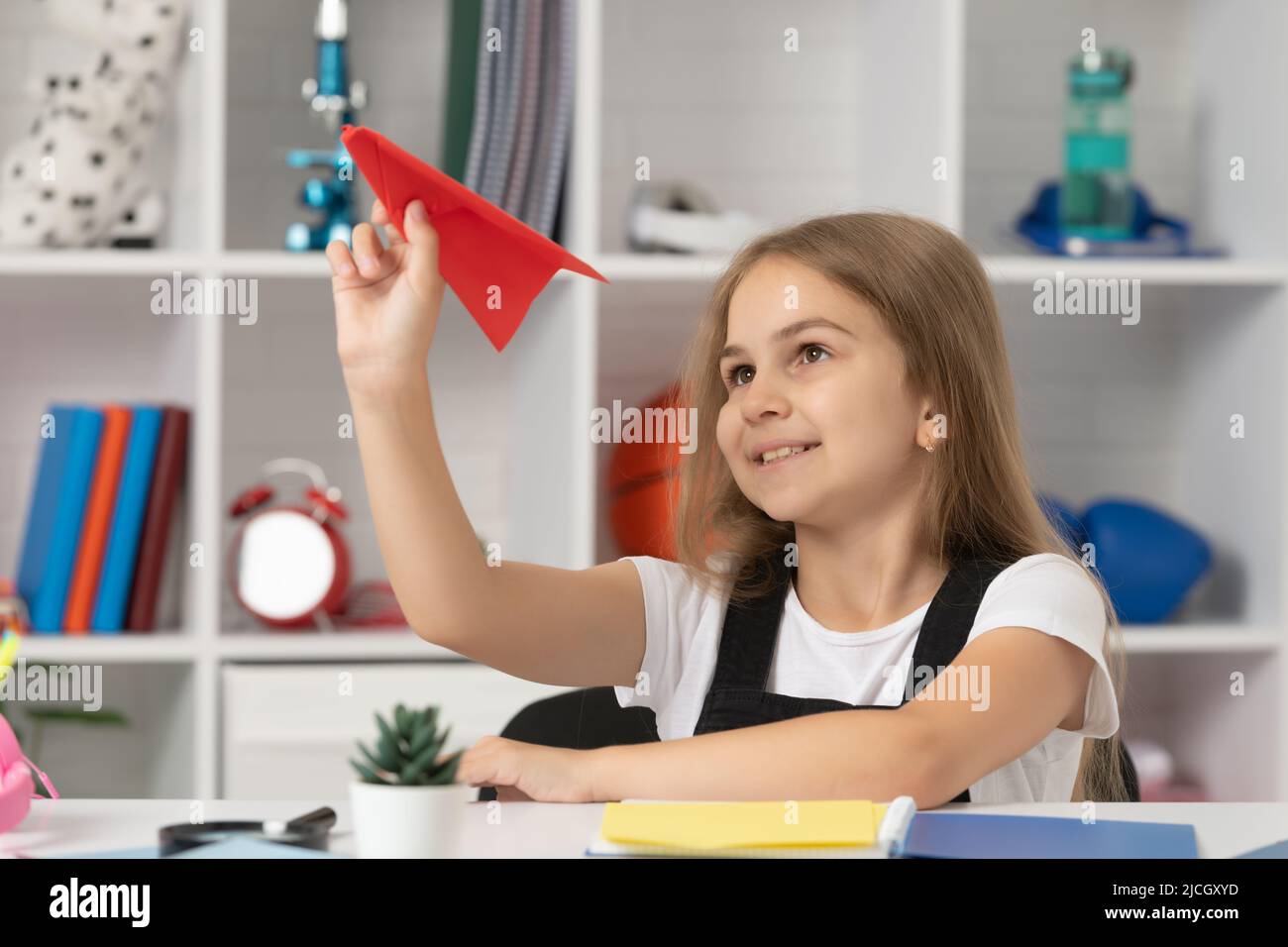 smiling kid play with paper plane in school classroom Stock Photo - Alamy
