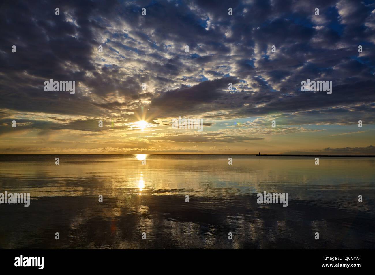 Golden dawn sun in the clouds over the bay. Amazing sunrise Stock Photo ...