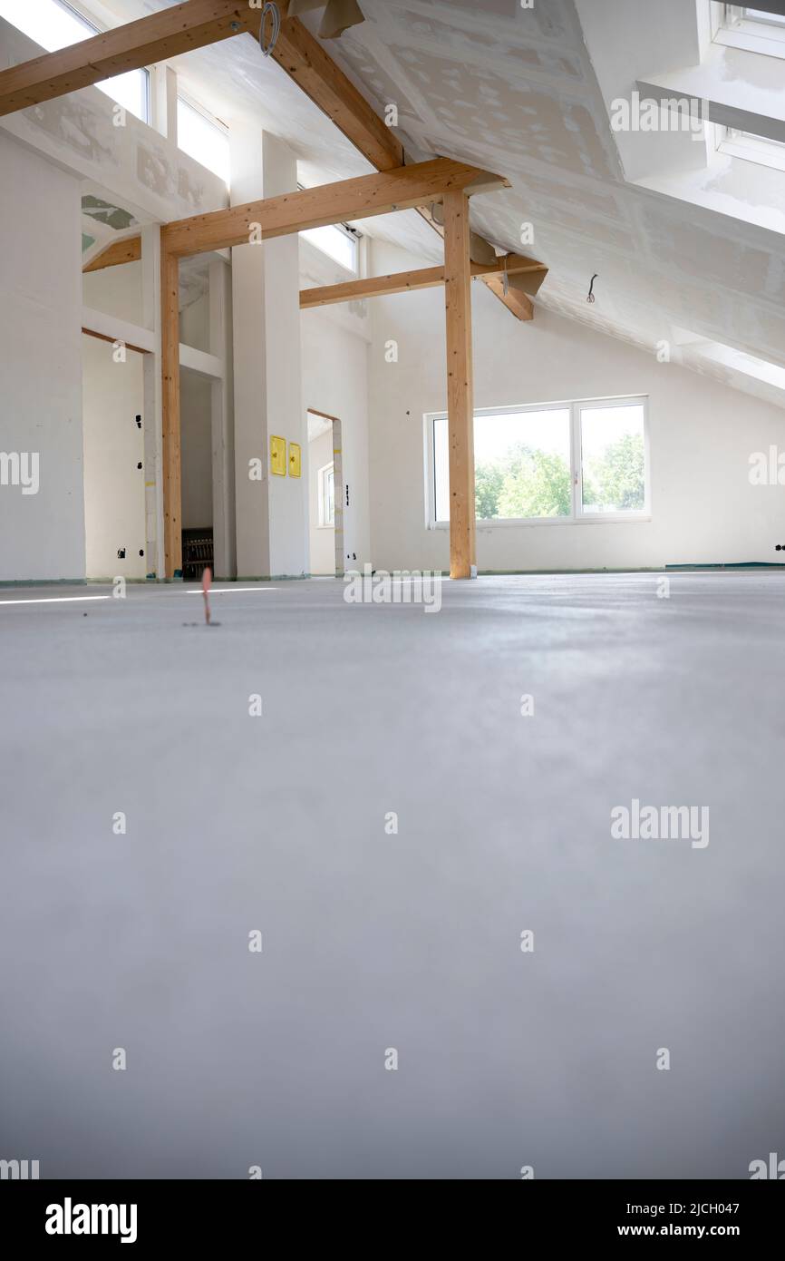 freshly cured concrete screed on construction site in loft in a family ...
