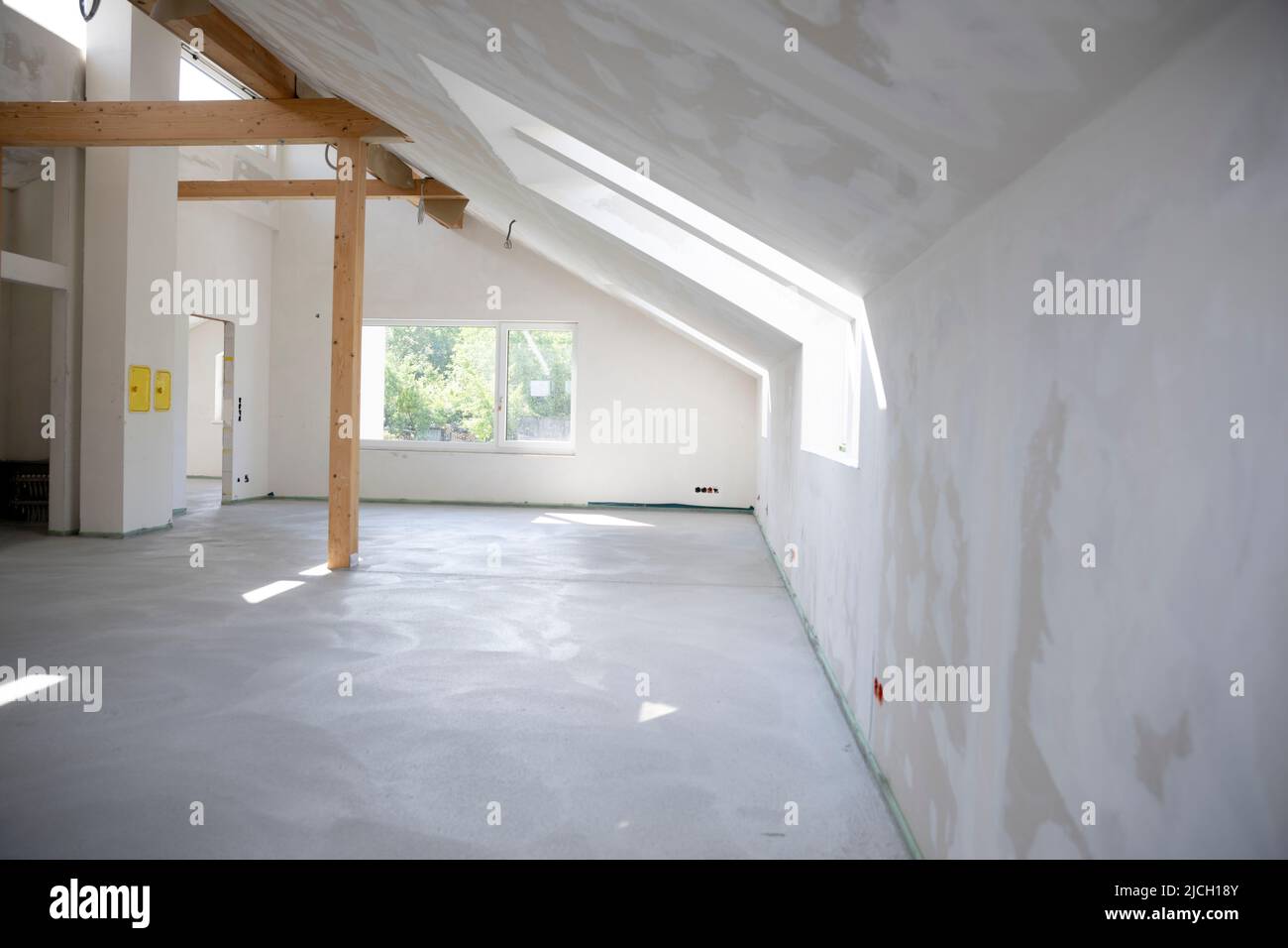 freshly cured concrete screed on construction site in loft in a family ...