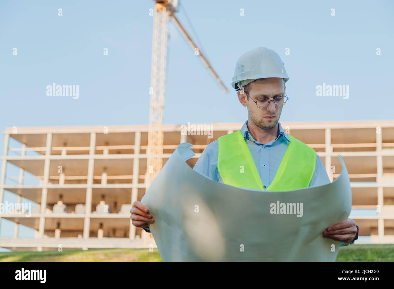 Male civil engineer with protective white helmet and reflective vest ...