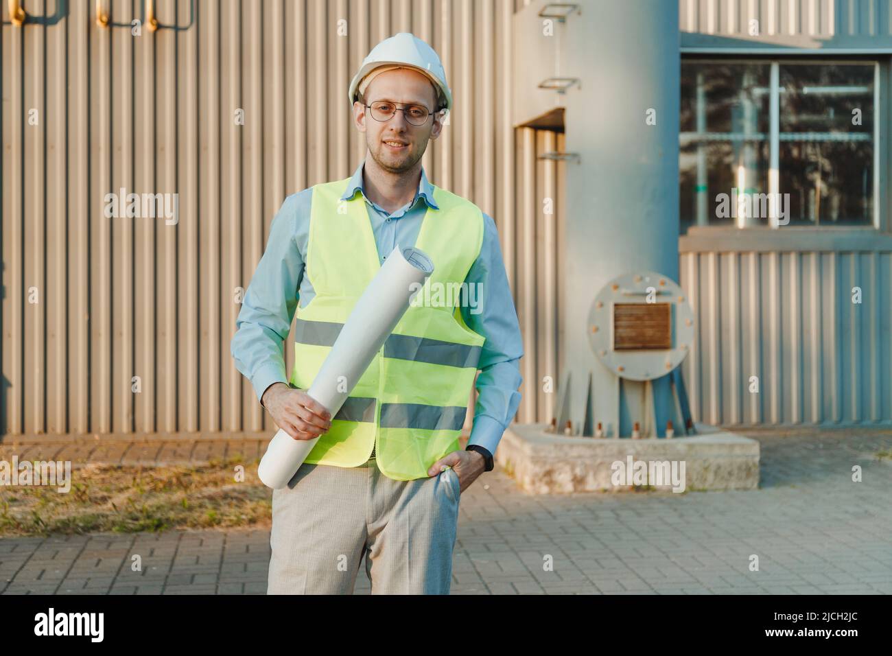 Foreman supervisor in suit and helmet on head, holding folder with ...