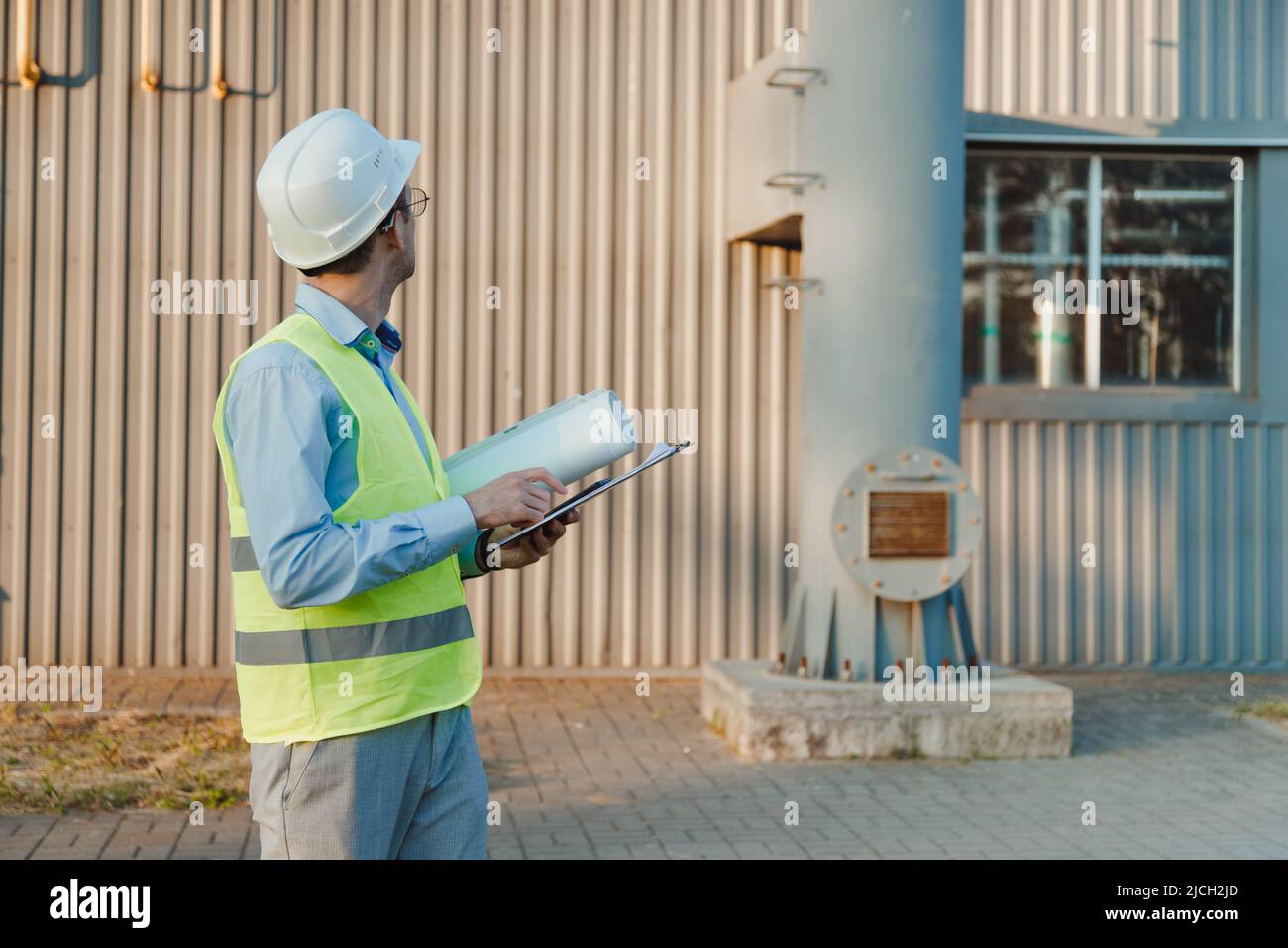 Foreman supervisor in suit and helmet on head, holding folder with ...
