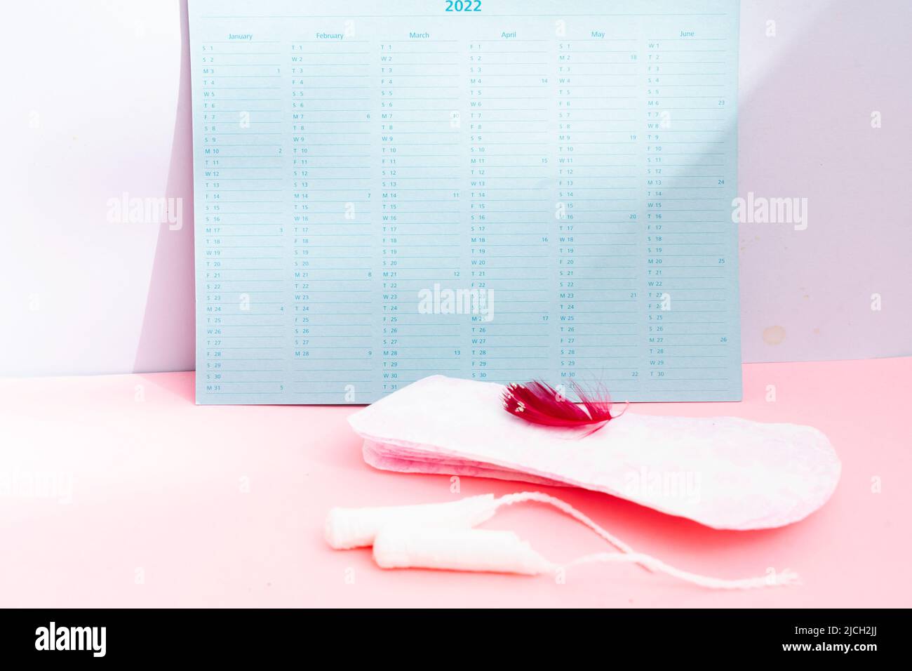 Menstrual pad with schedule card background Stock Photo - Alamy
