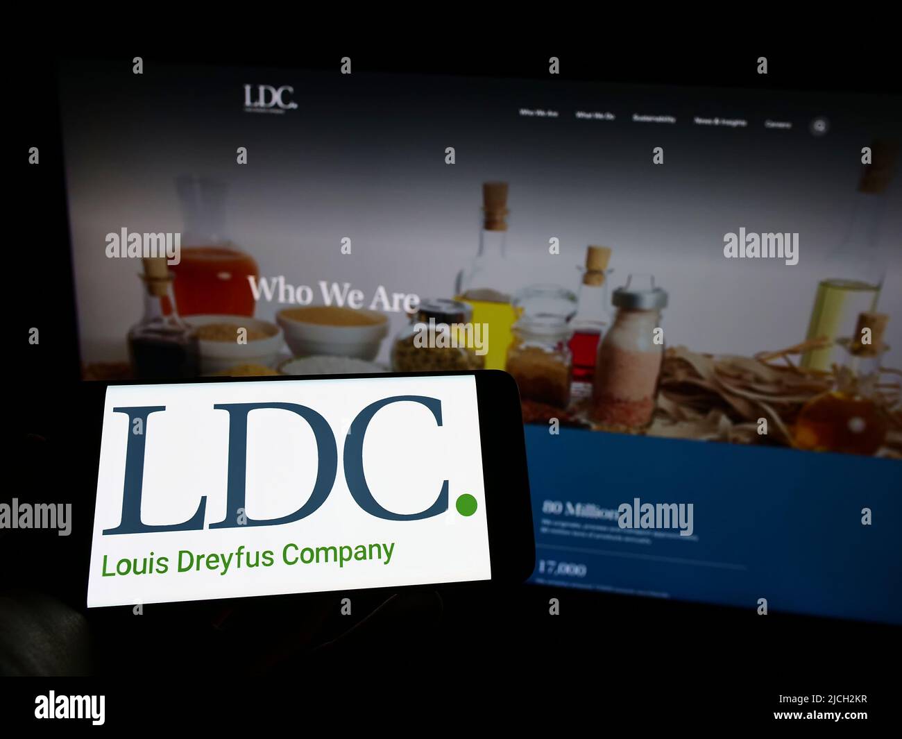 Person holding mobile phone with logo of Louis Dreyfus Company B.V ...