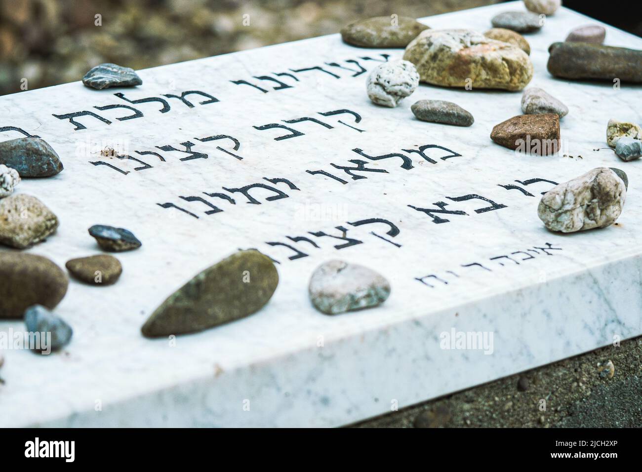 Memorial monument with small stones and Jewish texts in a former ...