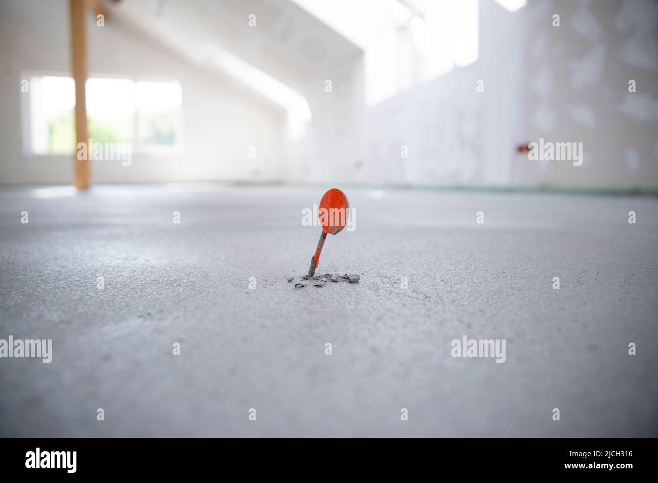 freshly cured concrete screed on construction site in loft in a family ...