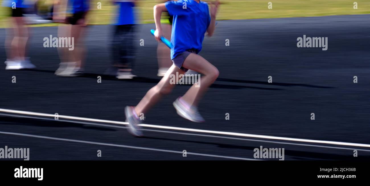 Person running a relay race on a track with blurred legs speed blur ...