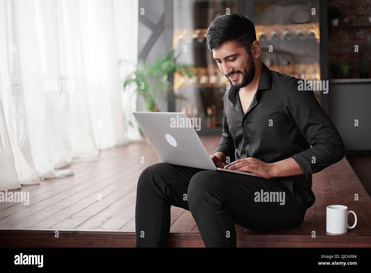 business owner using a laptop in his new store Stock Photo - Alamy